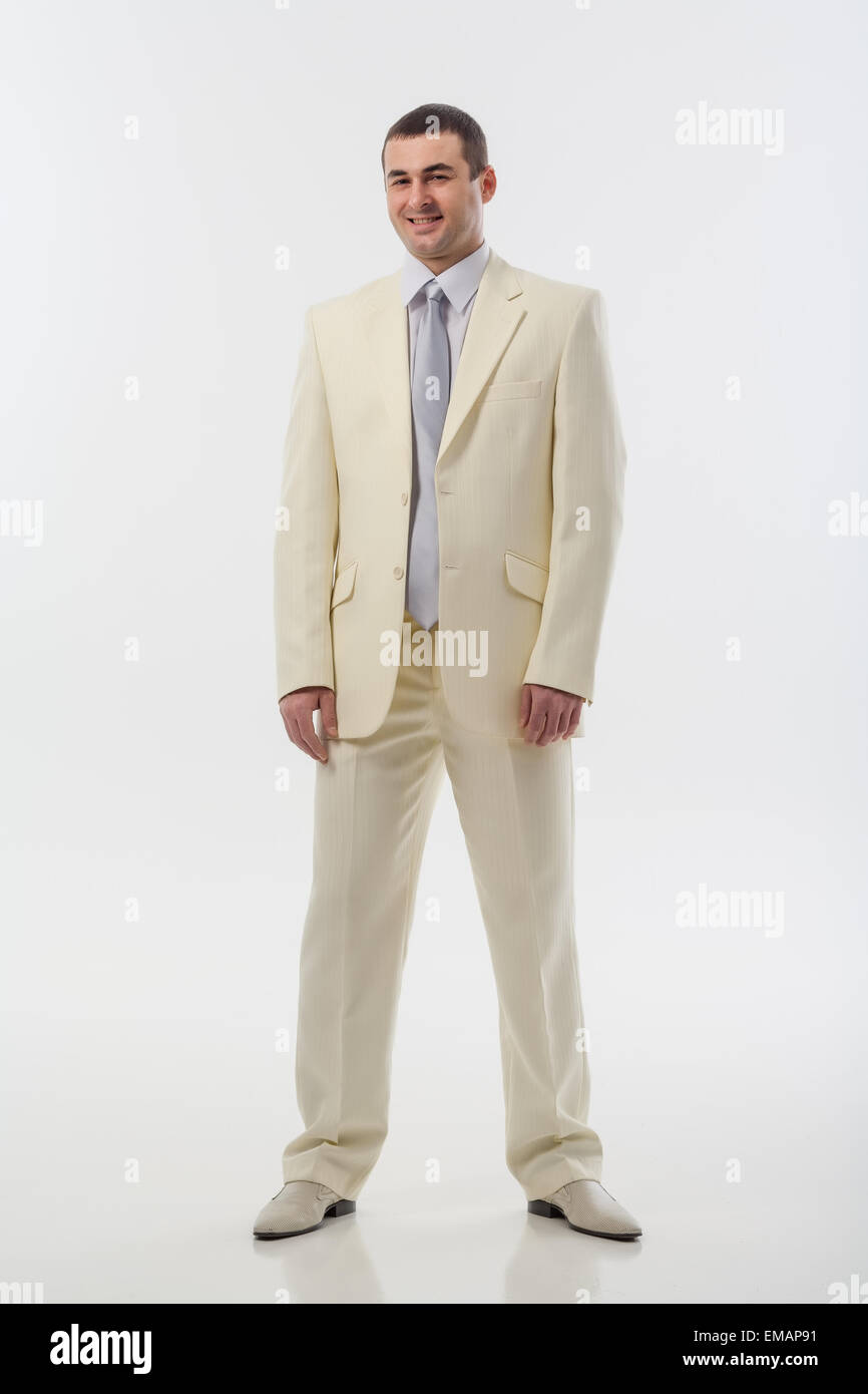 Friendly man in a white suit in studio. Makes hand gestures Stock Photo ...