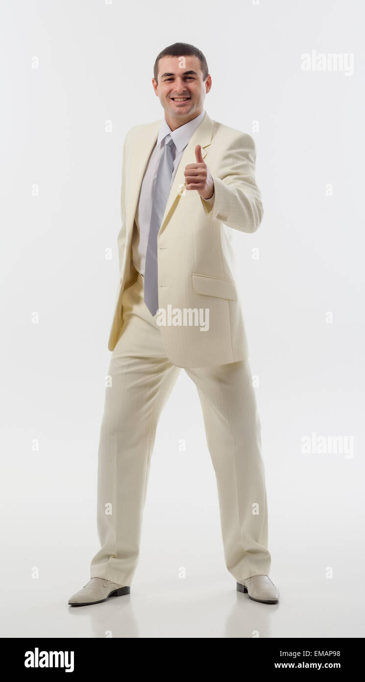 Friendly man in a white suit in studio. Makes hand gestures Stock Photo ...