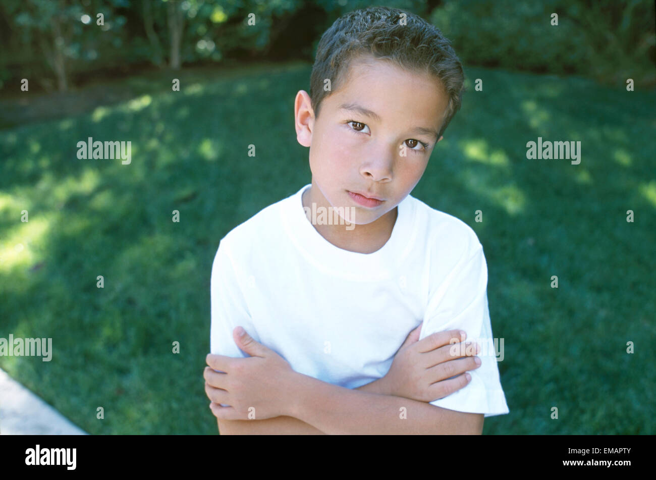 Portrait of pouting young boy in backyard Stock Photo - Alamy