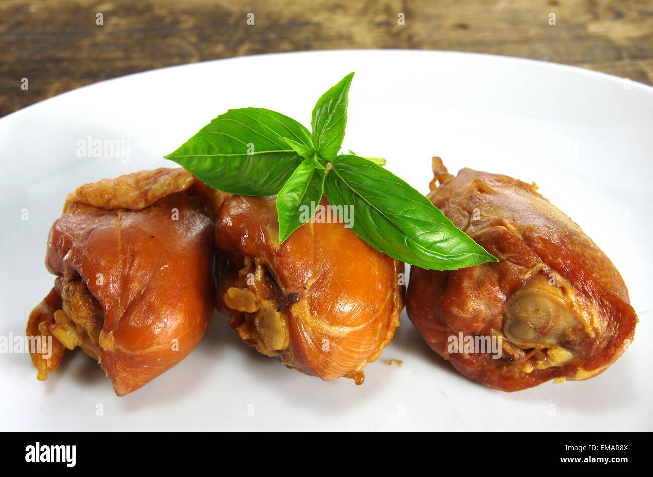 smoked chicken knuckle with green basil leaves Stock Photo - Alamy