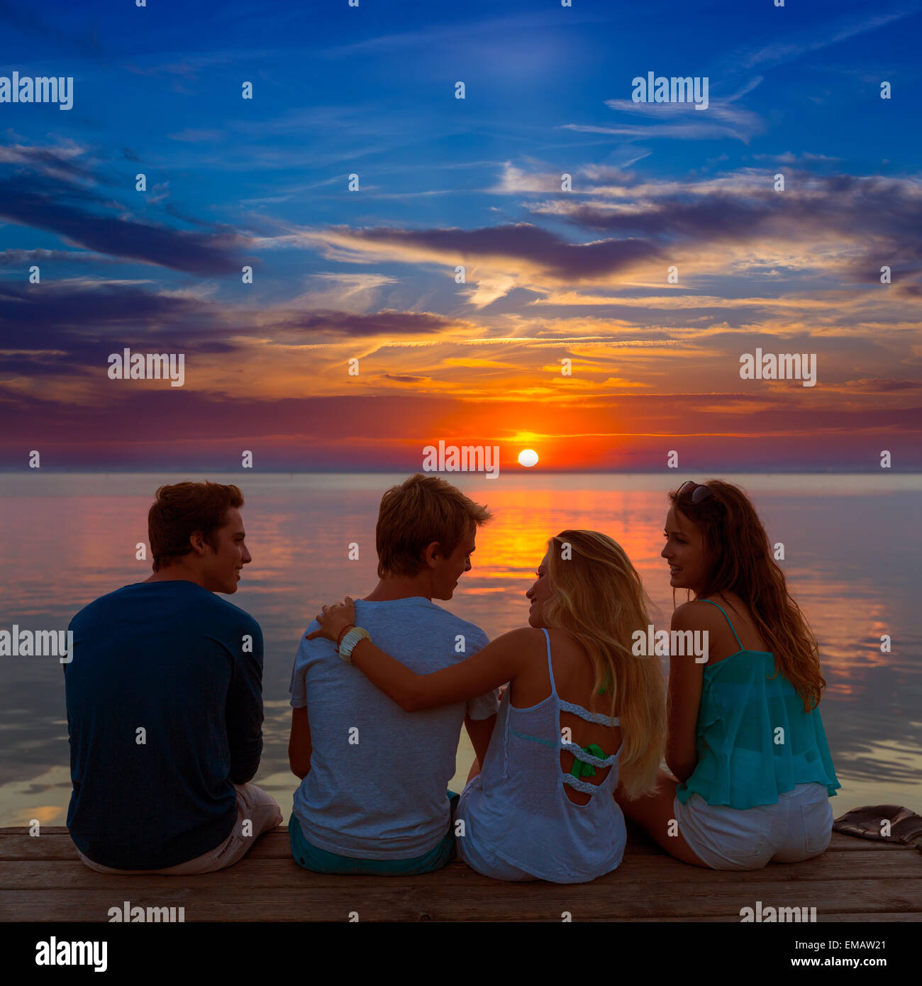 Friends group rear view at sunset happy fun together Stock Photo - Alamy