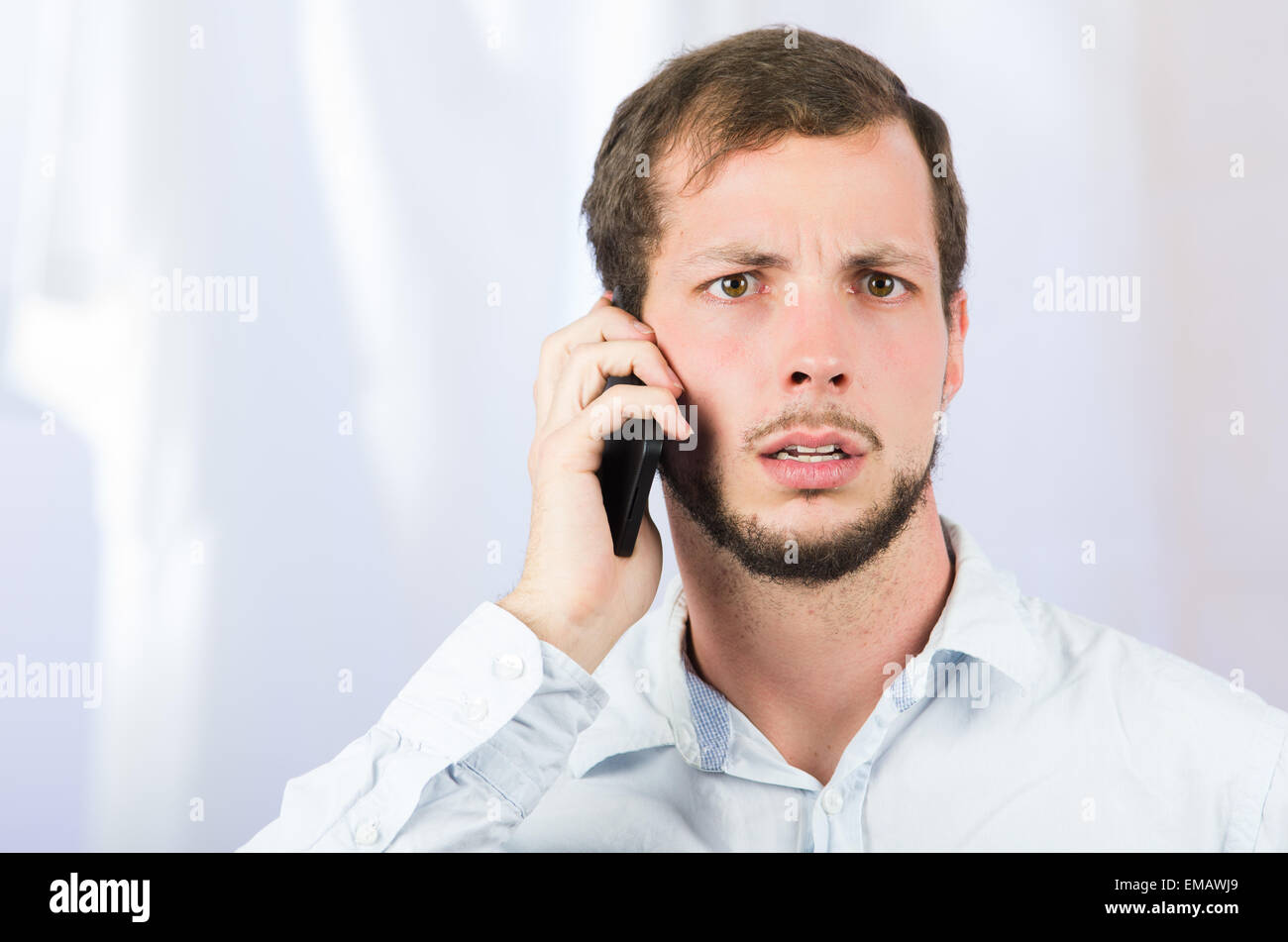 young handsome man using cell phone Stock Photo - Alamy