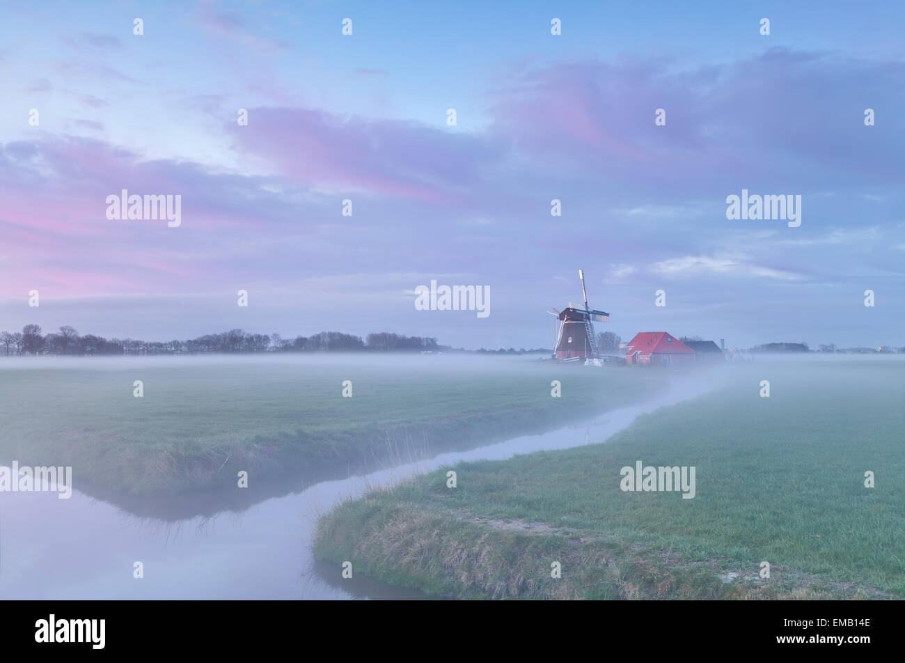 Dutch windmill at misty sunrise, Netherlands Stock Photo - Alamy