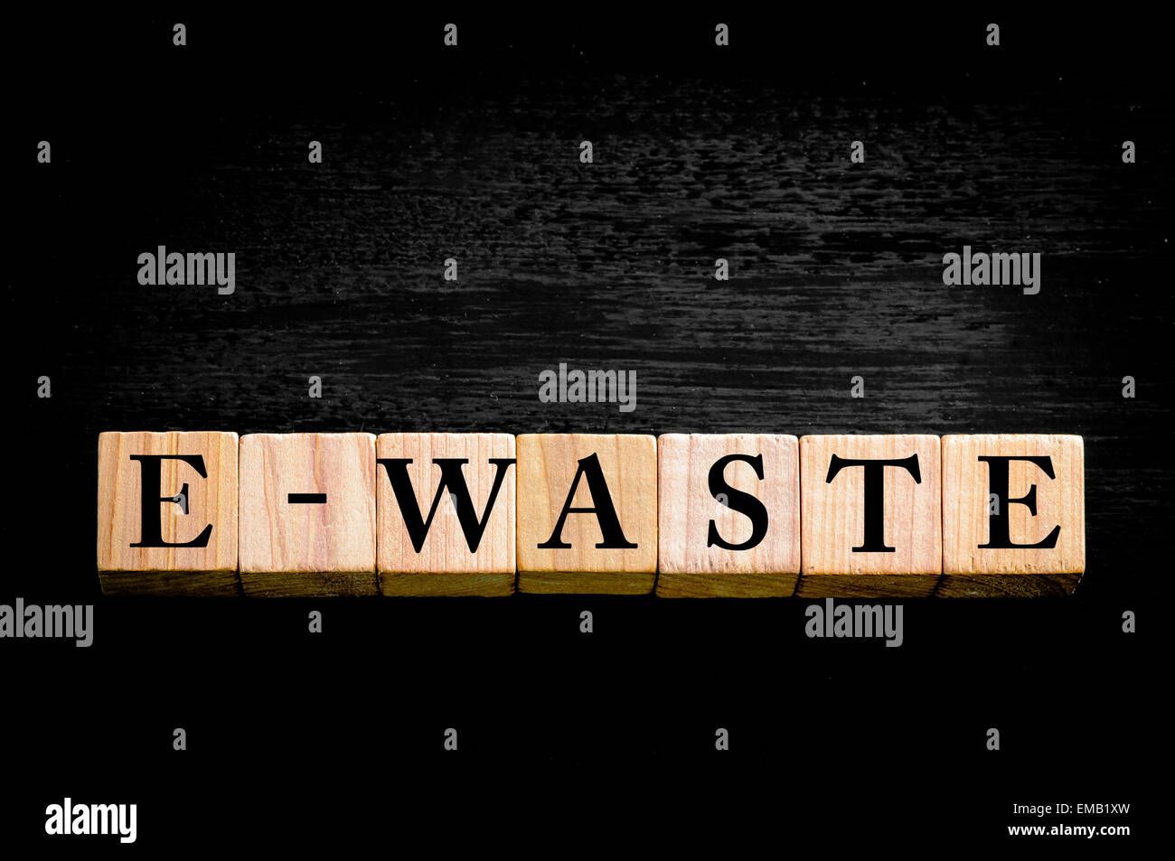 Word E-WASTE standing for ELECTRONIC WASTE. Wooden small cubes with ...