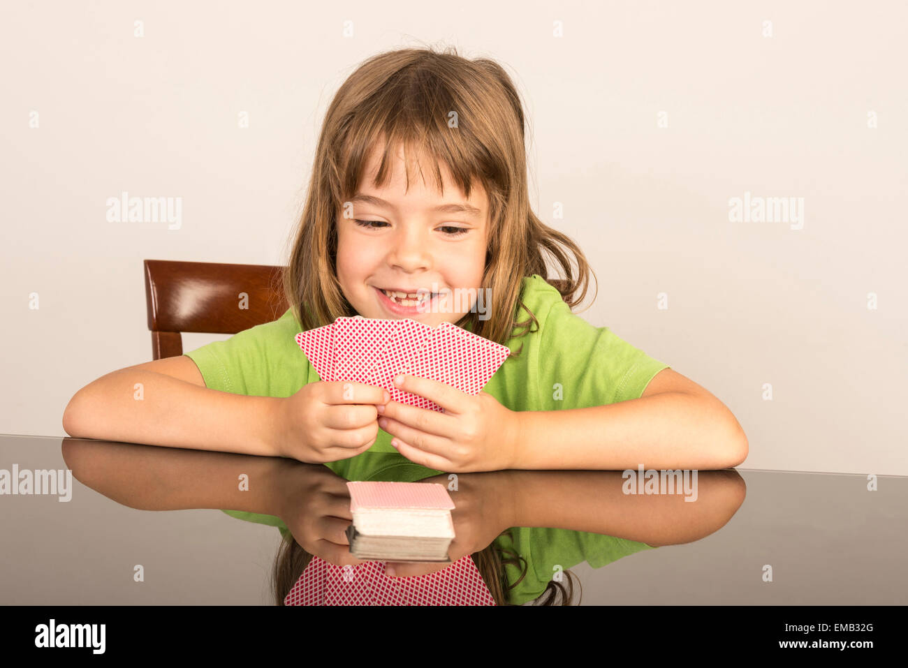 portrait of smiling little girl playing cards Stock Photo - Alamy