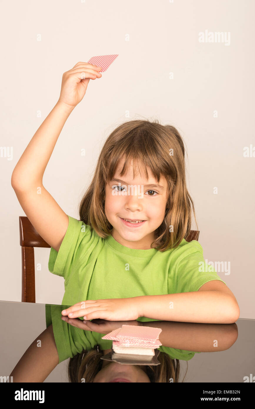 portrait of smiling little girl playing cards Stock Photo - Alamy