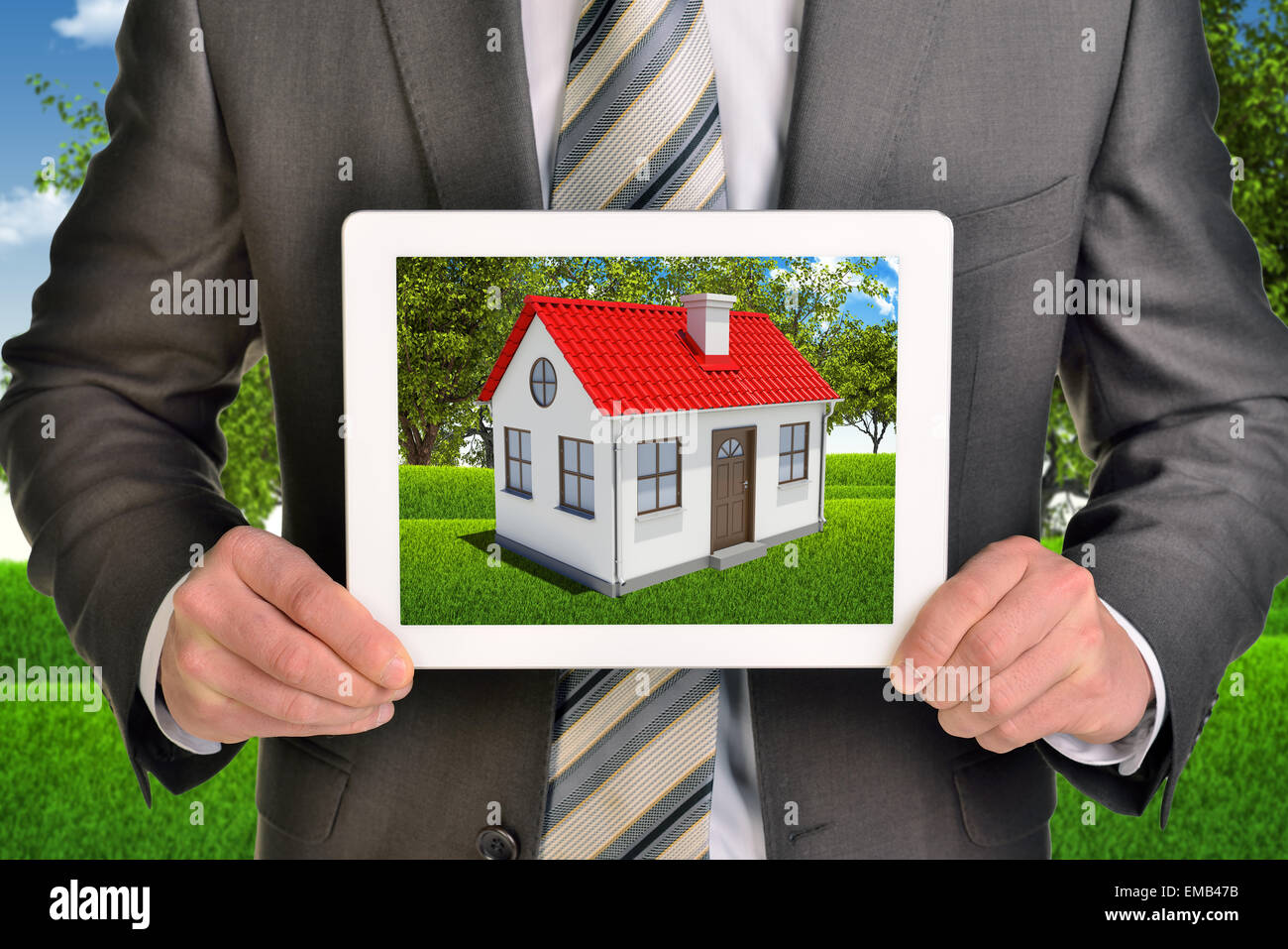 Estate agent showing photo with house on tablet screen Stock Photo - Alamy
