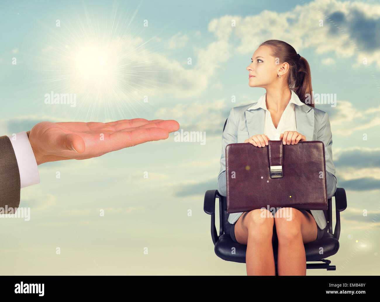 Young woman sitting in chair and looking at mans hand Stock Photo - Alamy