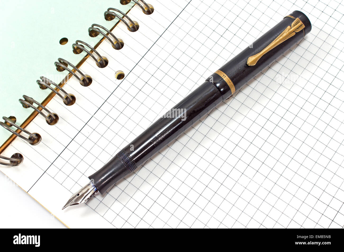 Fountain pen on spiral notebook Stock Photo - Alamy