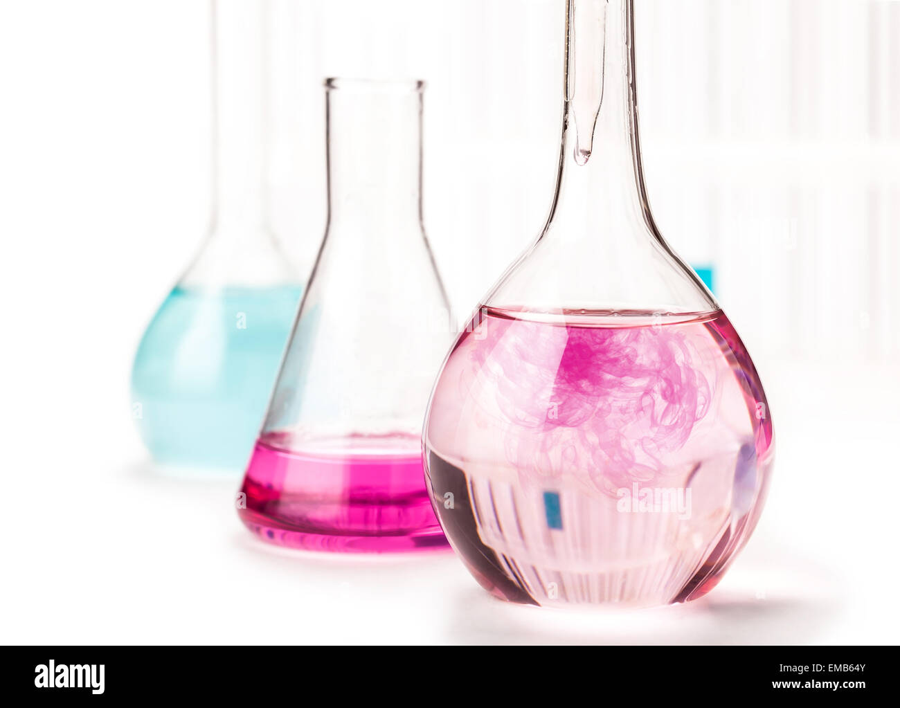 flask with reagent pink on a white background Stock Photo - Alamy