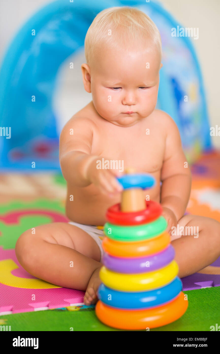 Cute baby is playing toy Stock Photo - Alamy