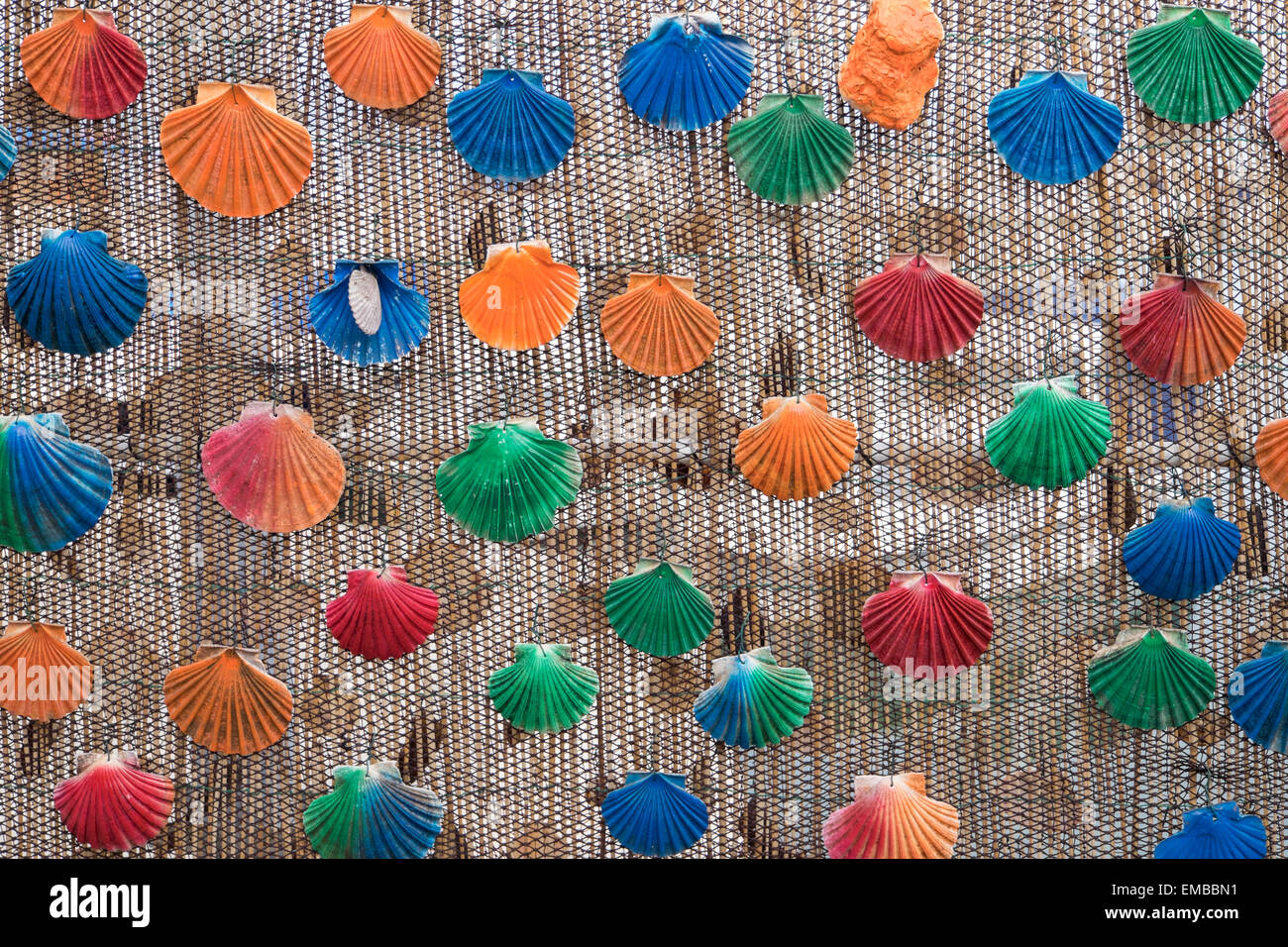 Coloured shells hanging on a net Stock Photo - Alamy