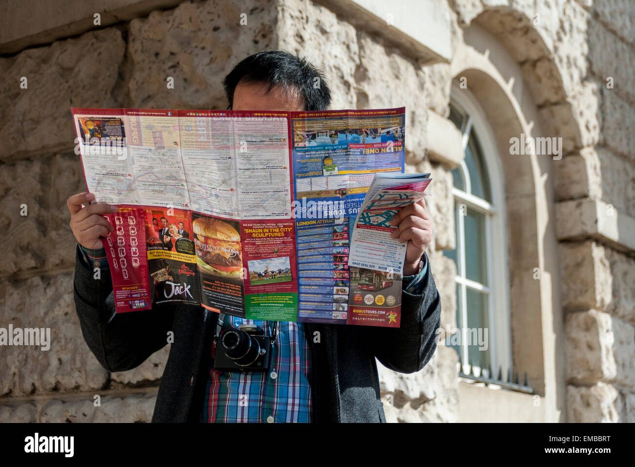 London, UK, 2 April 2015. A tourist studies a map at Horse Guards ...