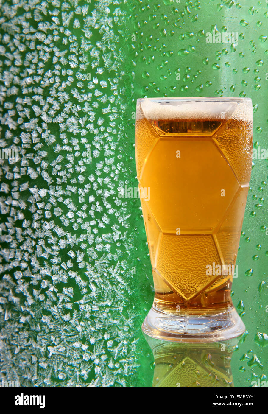 Fresh beer glass with reflection on ice crystals and drips green ...