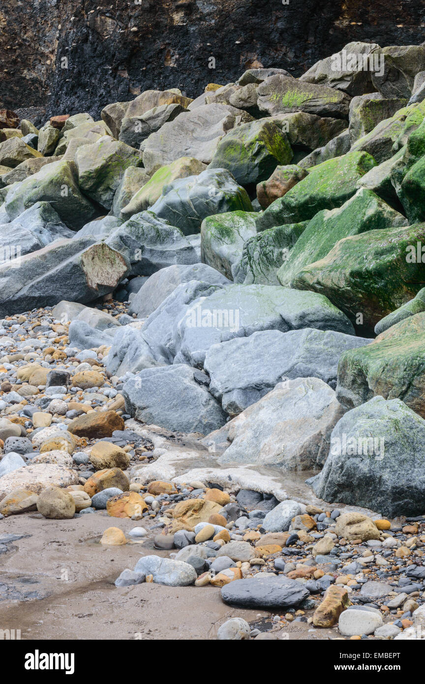 Layers of different size and coloured rocks on the beach, in Whitby ...