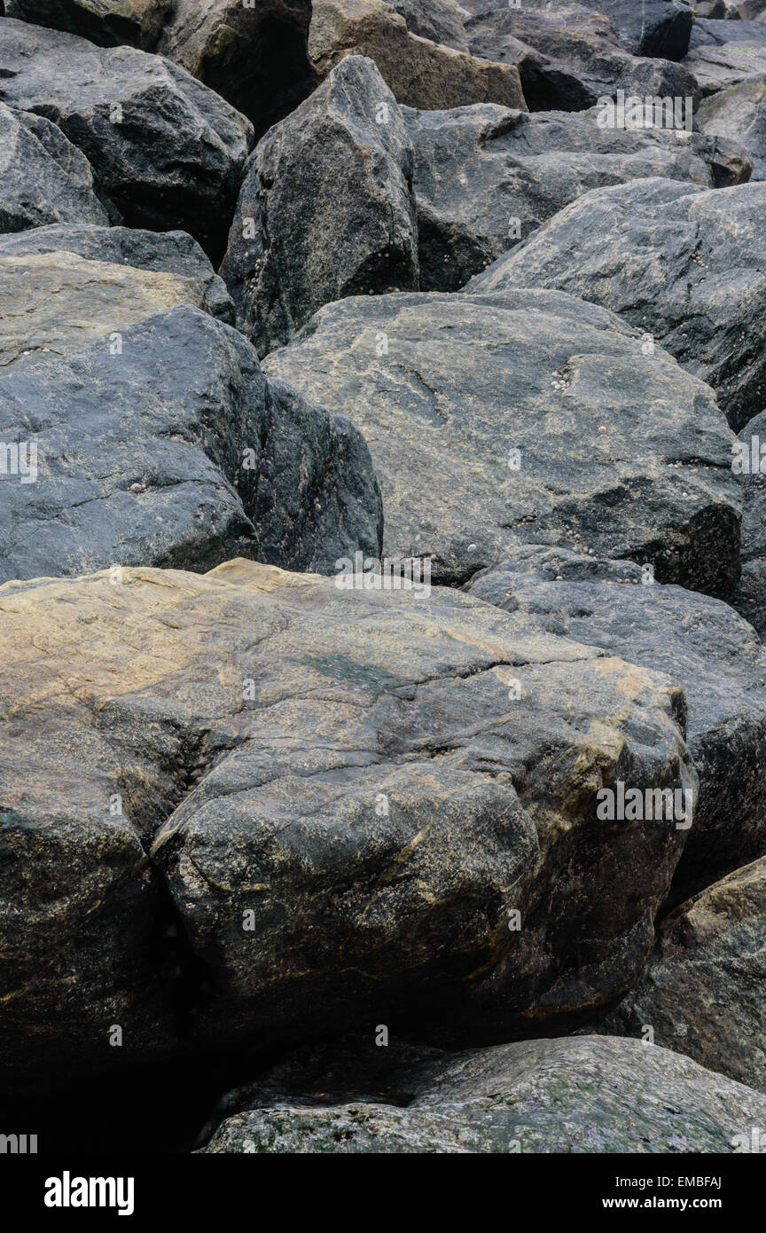 A pile of textured rocks on the beach in Whitby, North Yorkshire ...