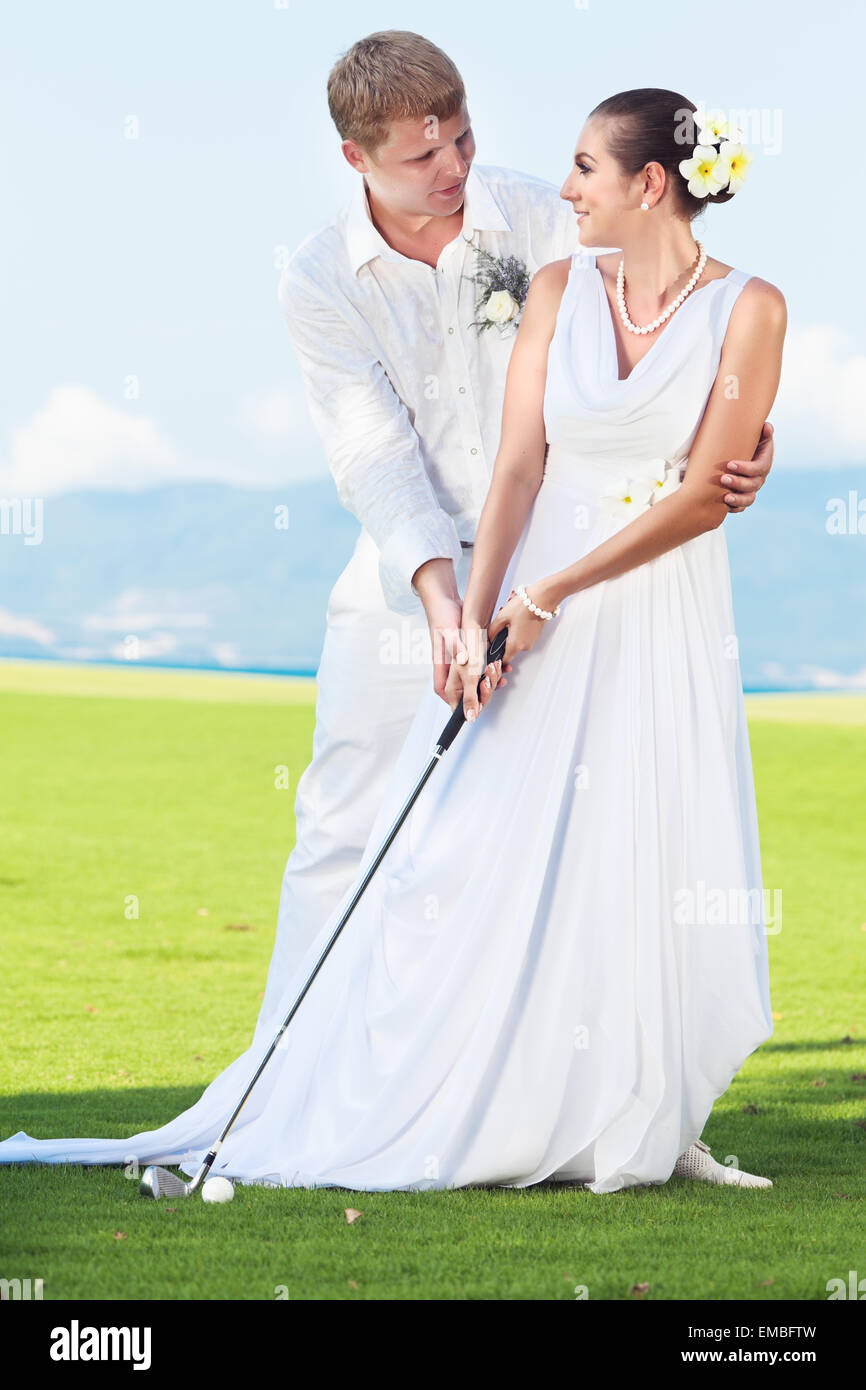 Bride and groom are playing golf at wedding day Stock Photo - Alamy
