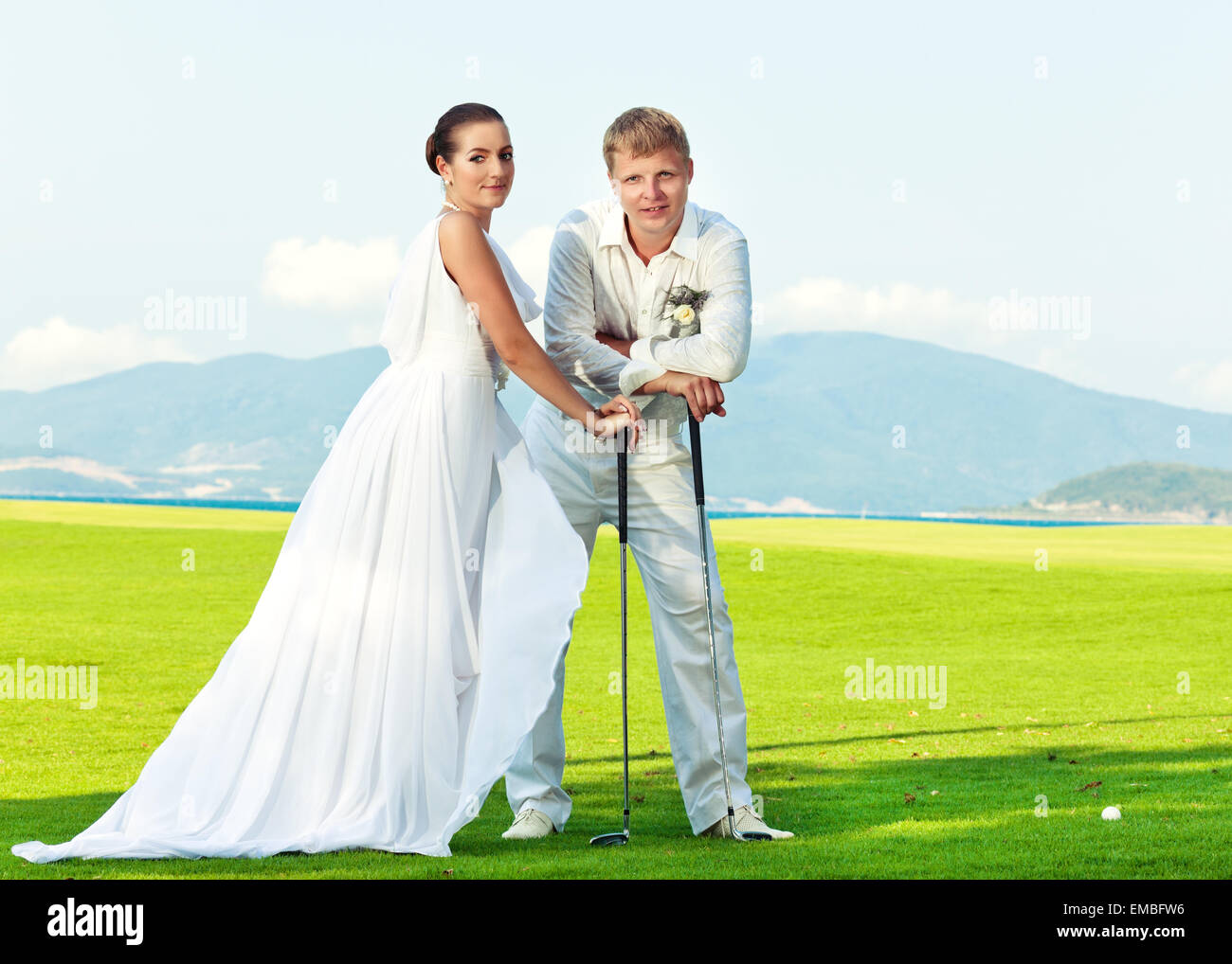 Bride and groom are playing golf at wedding day Stock Photo - Alamy