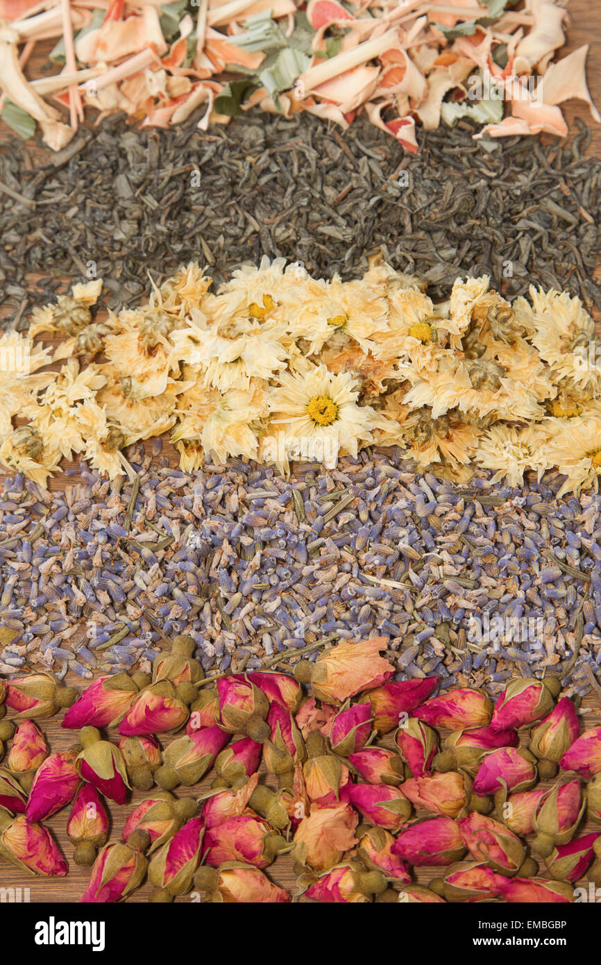 Assortment of dried tea in wooden background Stock Photo - Alamy