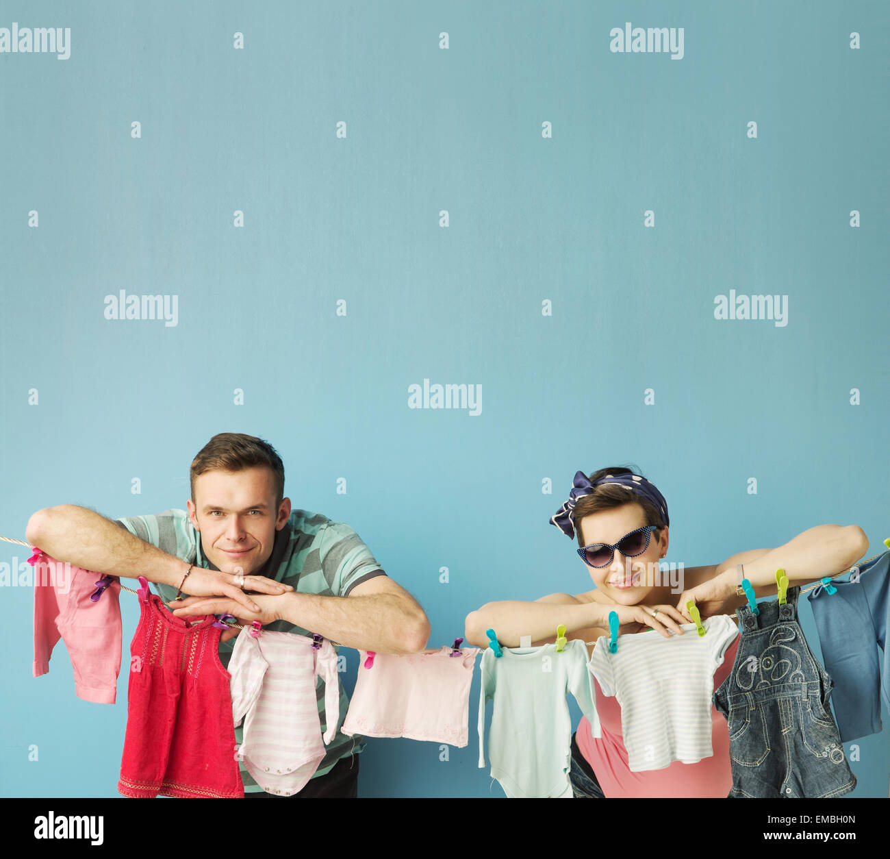 Happy attractive parents doing the laundry Stock Photo - Alamy