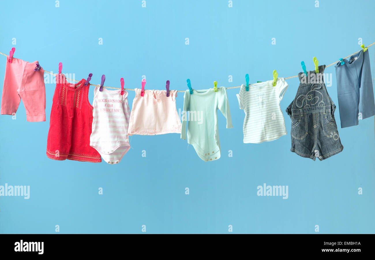 Washing line with baby clothing hi-res stock photography and images - Alamy