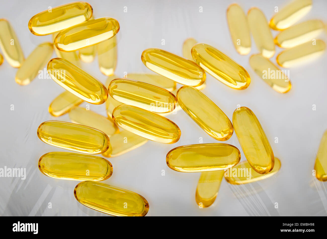 omega-3 fish fat oil capsules on grey background Stock Photo - Alamy
