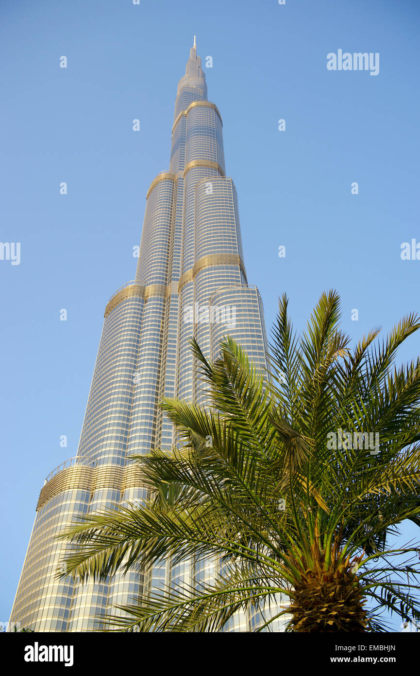 Dubai skyline features modern skyscraper of Burj Khalifa and date palm ...