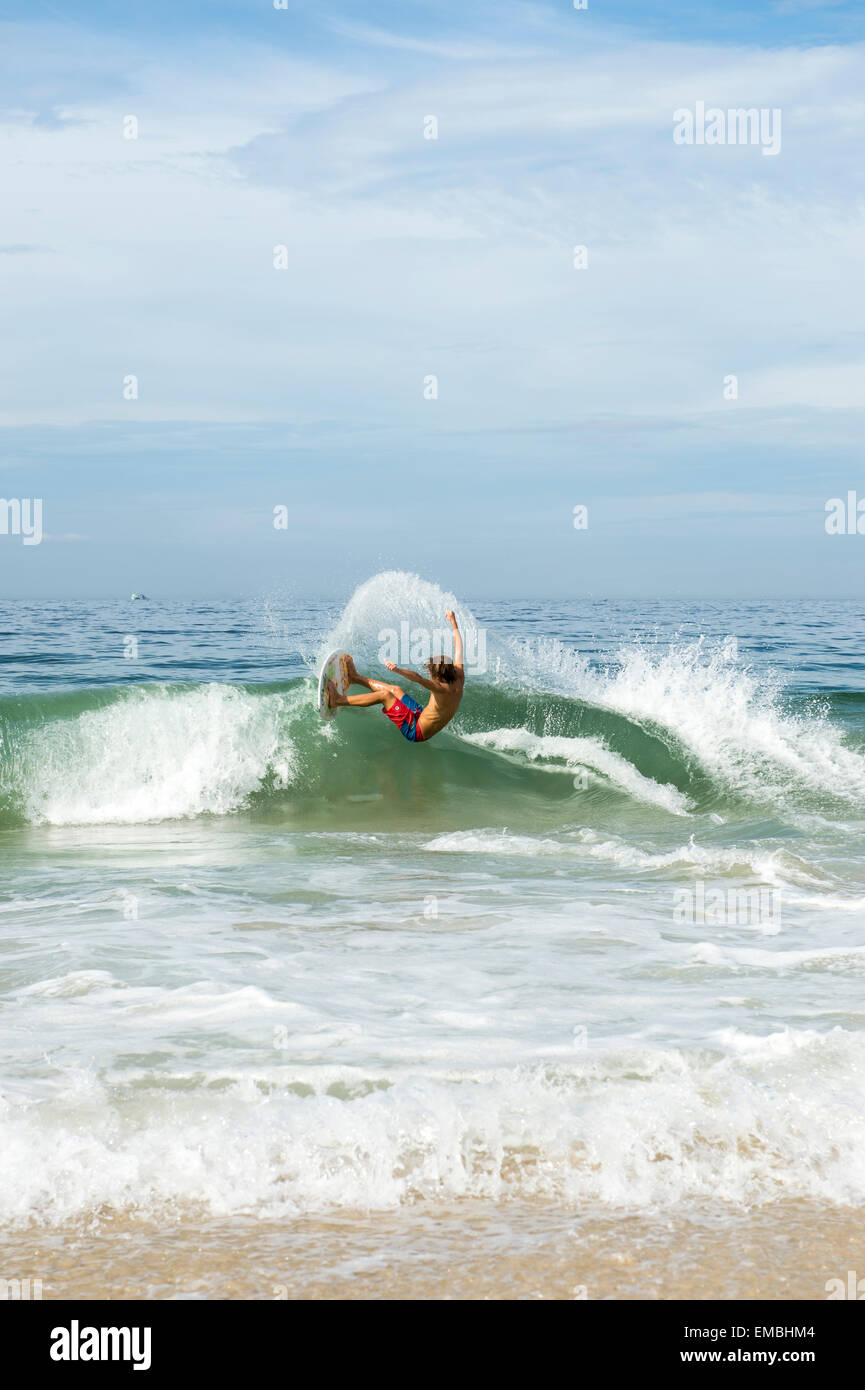Brazilian surfer skimboarder carving a fan into the the wave with his ...