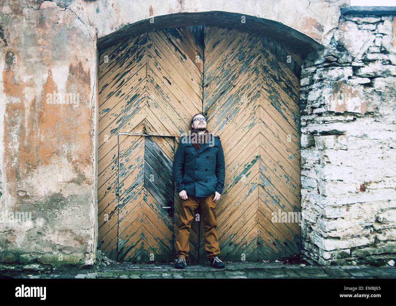Man standing on front of the gate, looking up and dreaming Stock Photo ...