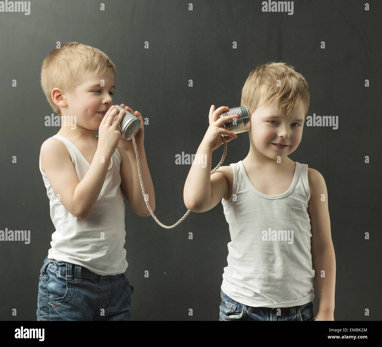Cute little siblings talking on the toy phone Stock Photo - Alamy