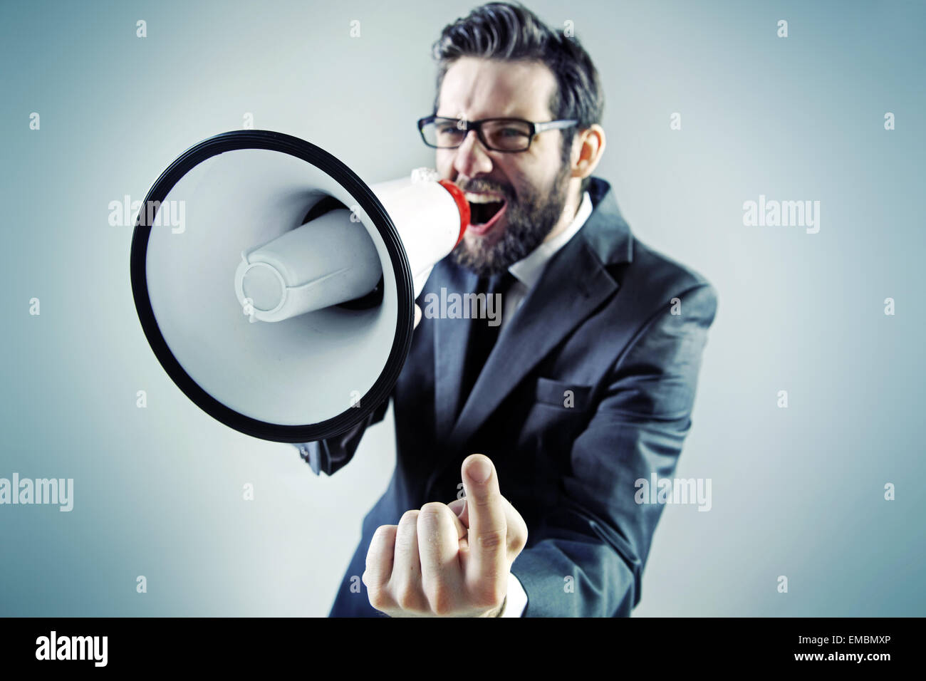 angry businessman with megaphone Stock Photo - Alamy
