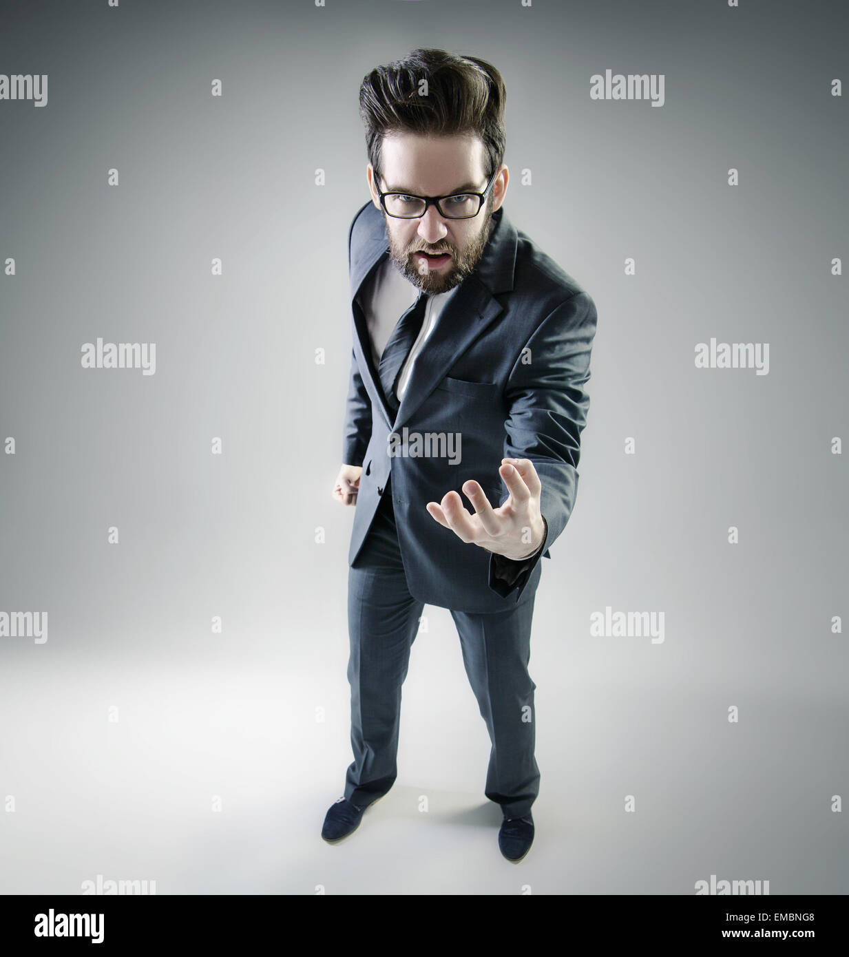 Angry businessman posing in elegant suit Stock Photo - Alamy