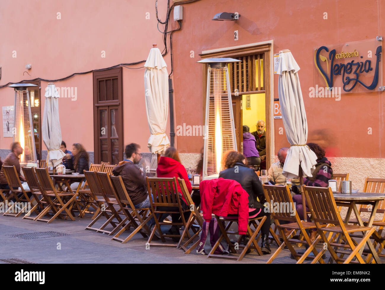 Patio heaters outside street bar at night in San Cristobal de La Laguna ...