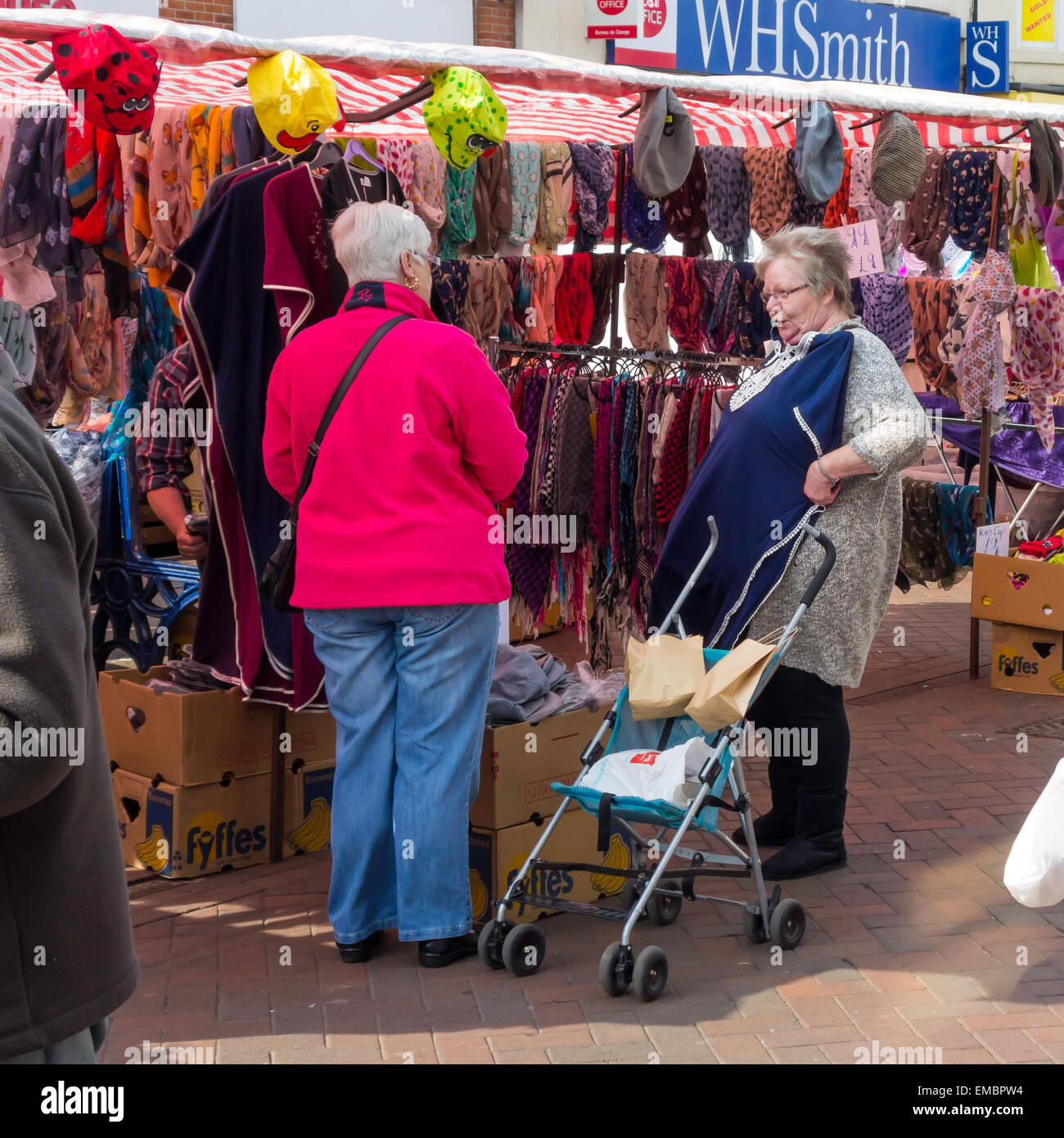 Street Market in Redcar Cleveland, two women discussing purchase of a ...