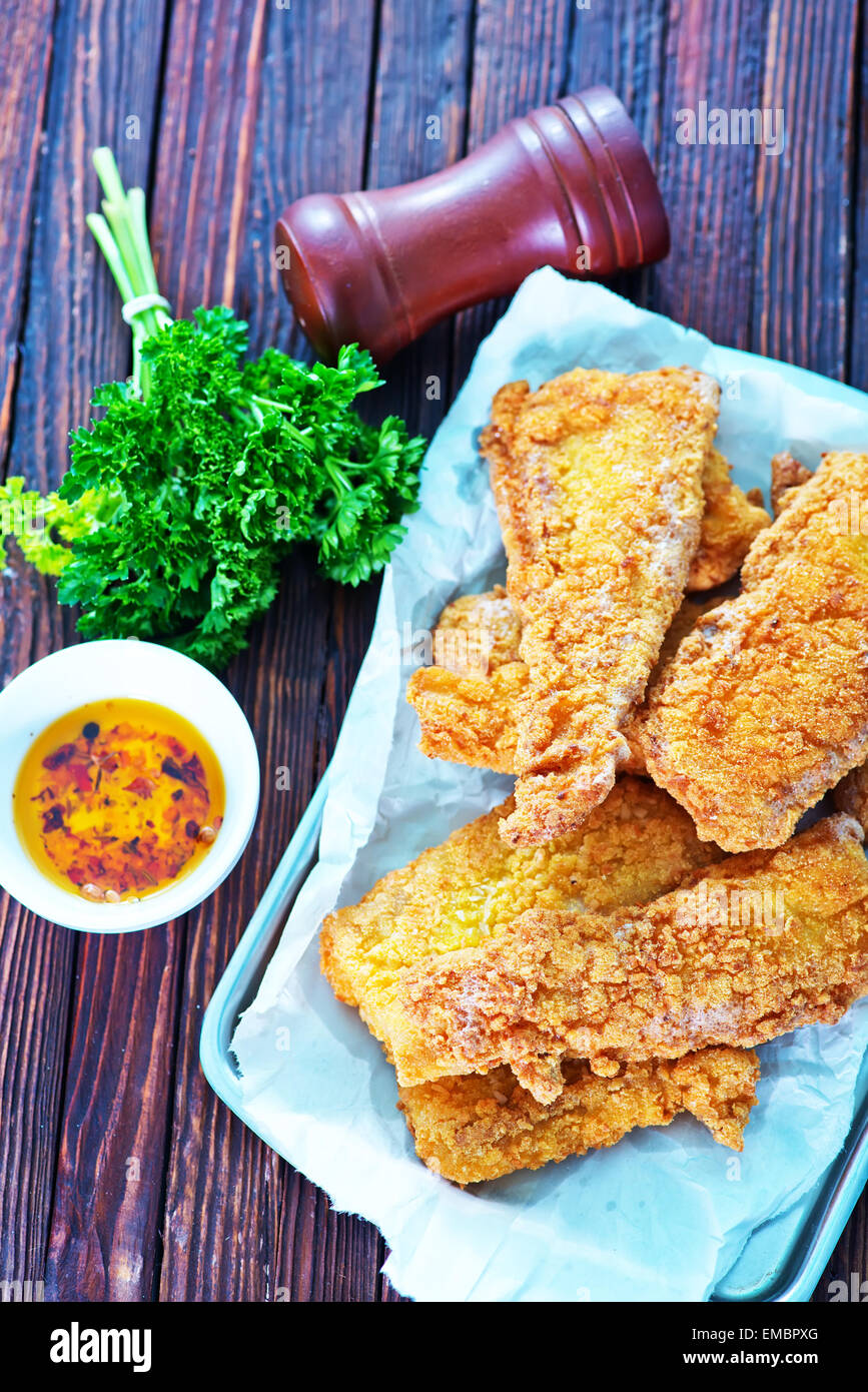 fried fish on tray and on a table Stock Photo - Alamy