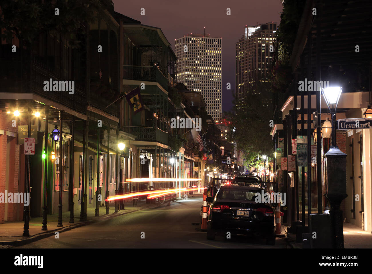 Night view of the street in French Quarter with high-rise buildings in ...