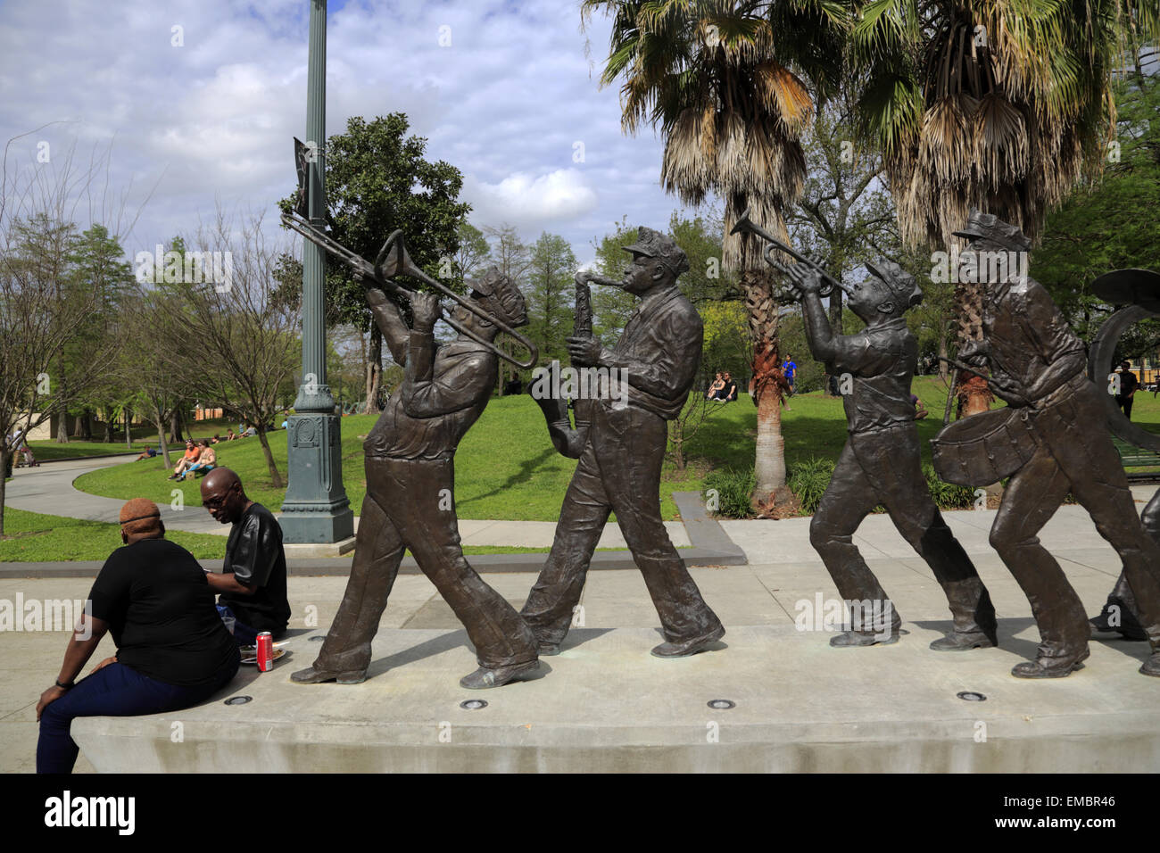 People relax by the "Brass Band" a grouping of bronze statues in Congo ...