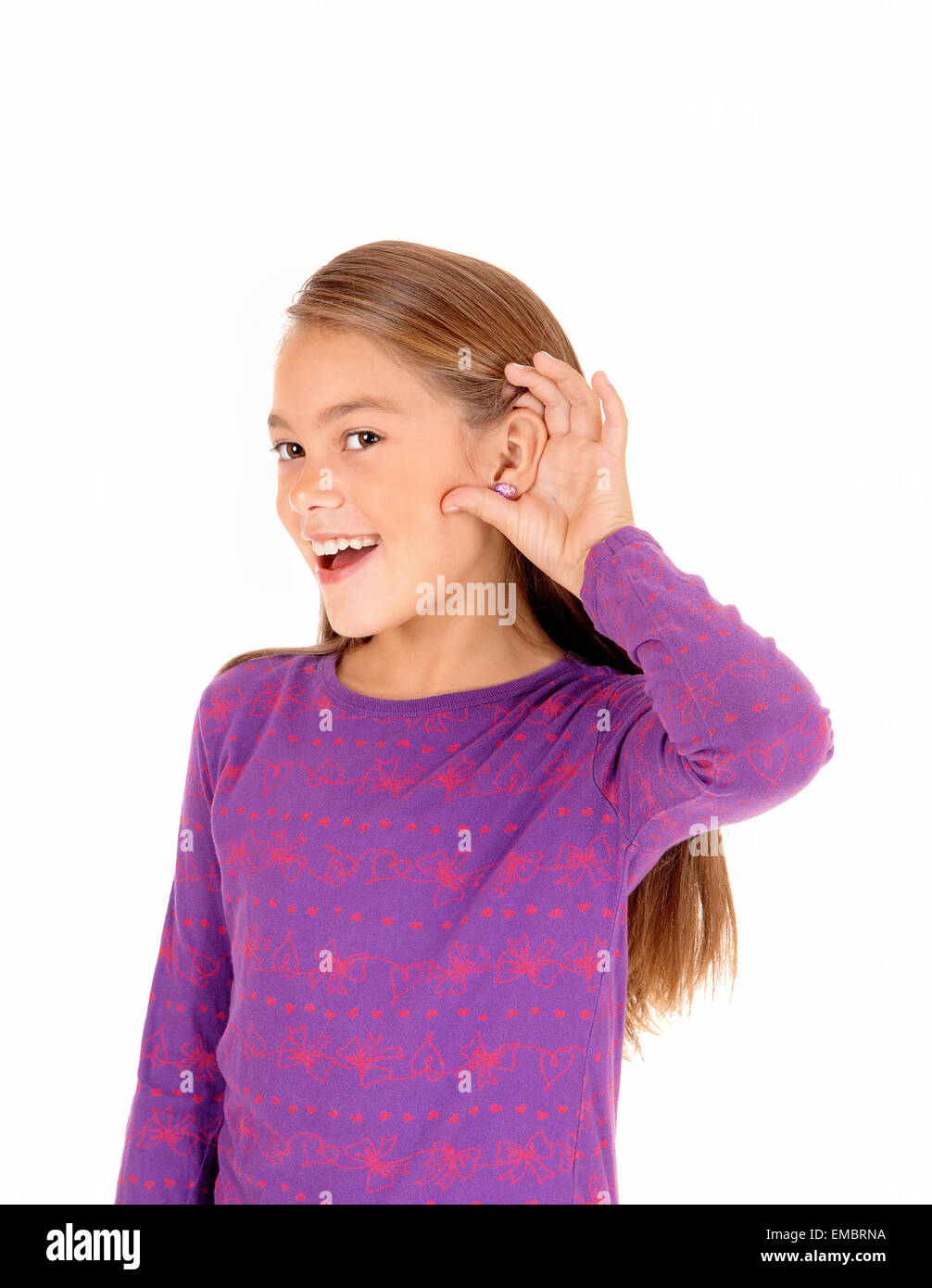 A blond pretty girl with her hand behind her ear standing for white ...