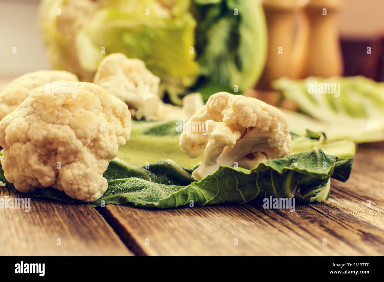 Raw cauliflower with leaf on wood table Stock Photo - Alamy