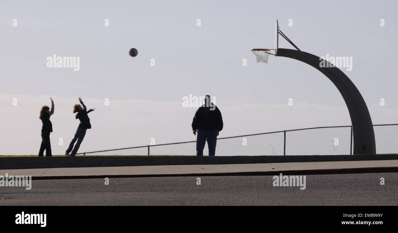 Father coaching teenagers' basketball Stock Photo - Alamy