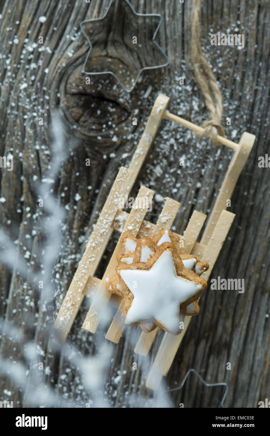 Stack of cinnamon stars on miniature sledge Stock Photo - Alamy