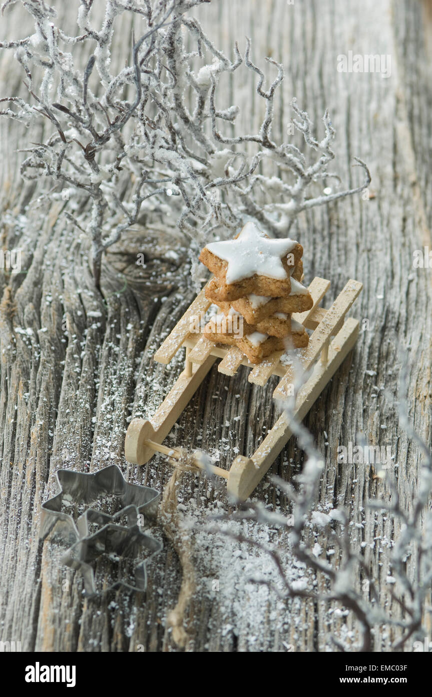 Stack of cinnamon stars on miniature sledge Stock Photo - Alamy