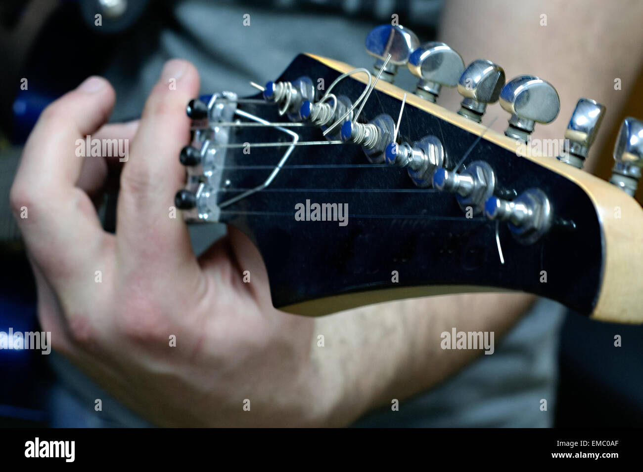 Electric guitar close up with hand playing it Stock Photo - Alamy
