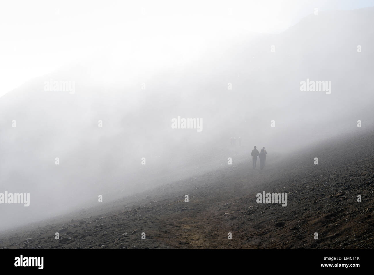 USA, Hawaii, Maui, Haleakala, hikers in fog inside the volcanic crater ...
