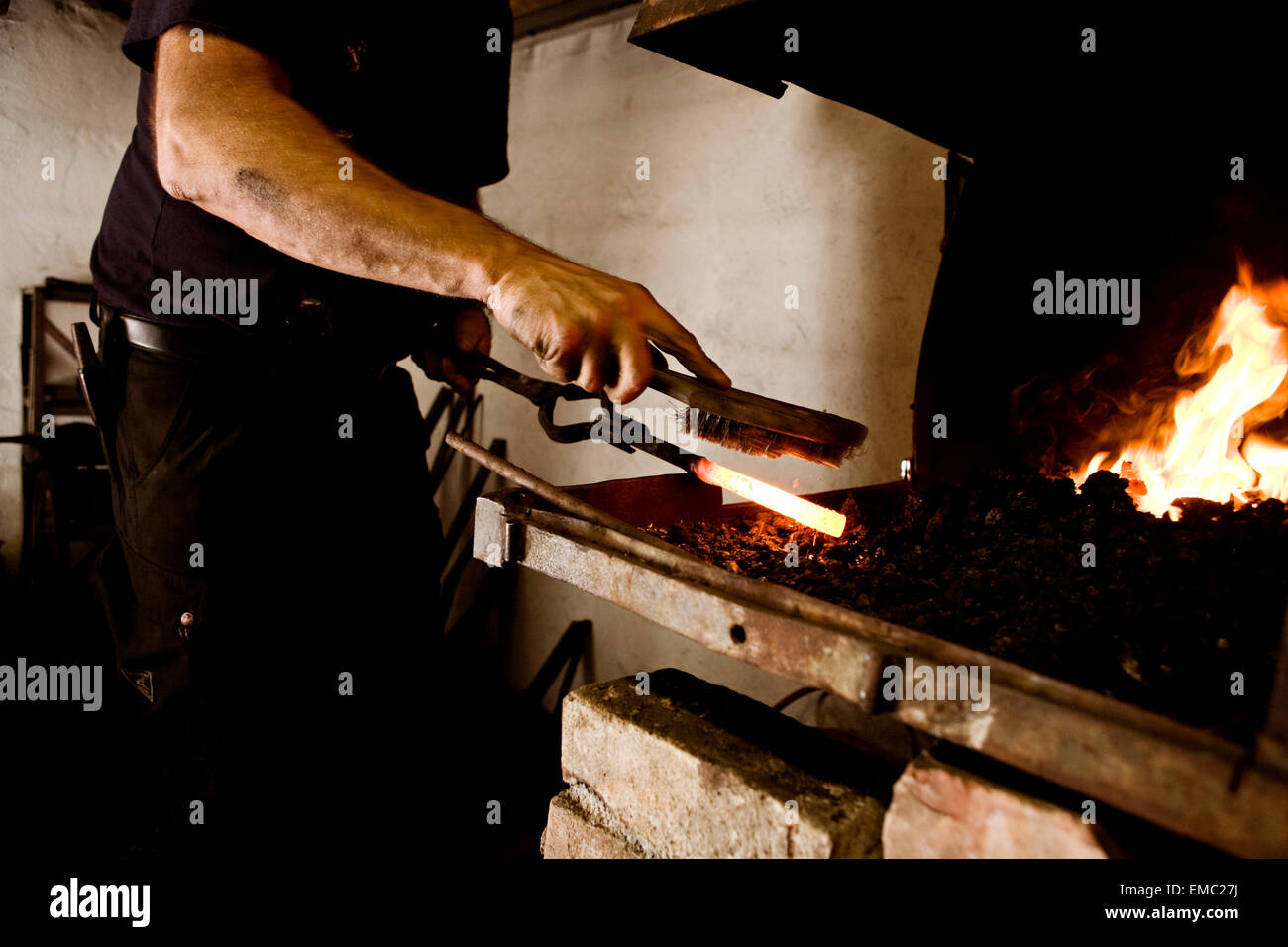 Blacksmith at work at the fireplace Stock Photo - Alamy
