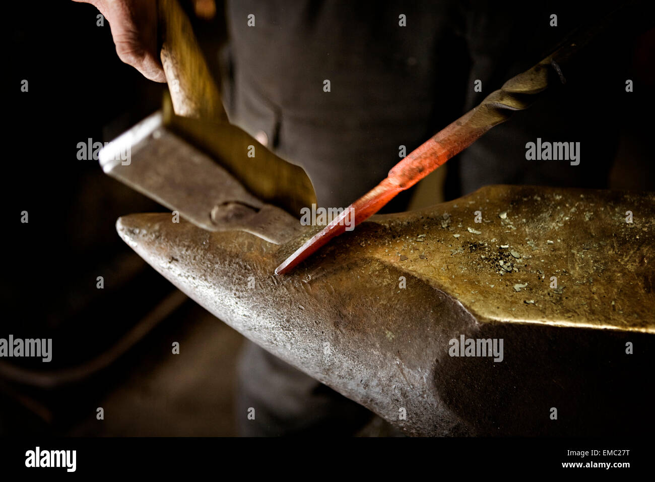 Blacksmith working with hammer at anvil Stock Photo - Alamy