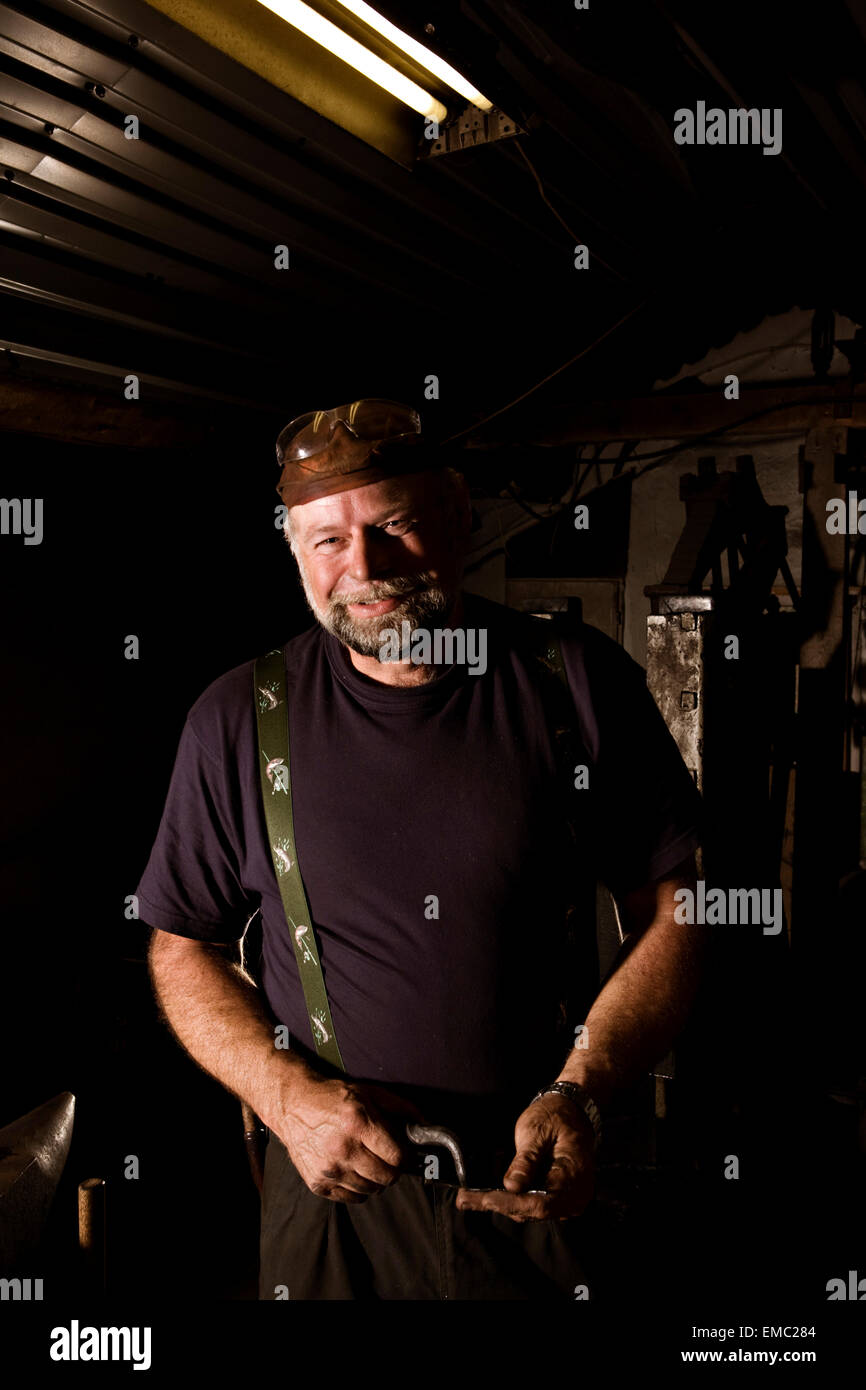 Portrait of smiling blacksmith in his workshop Stock Photo - Alamy
