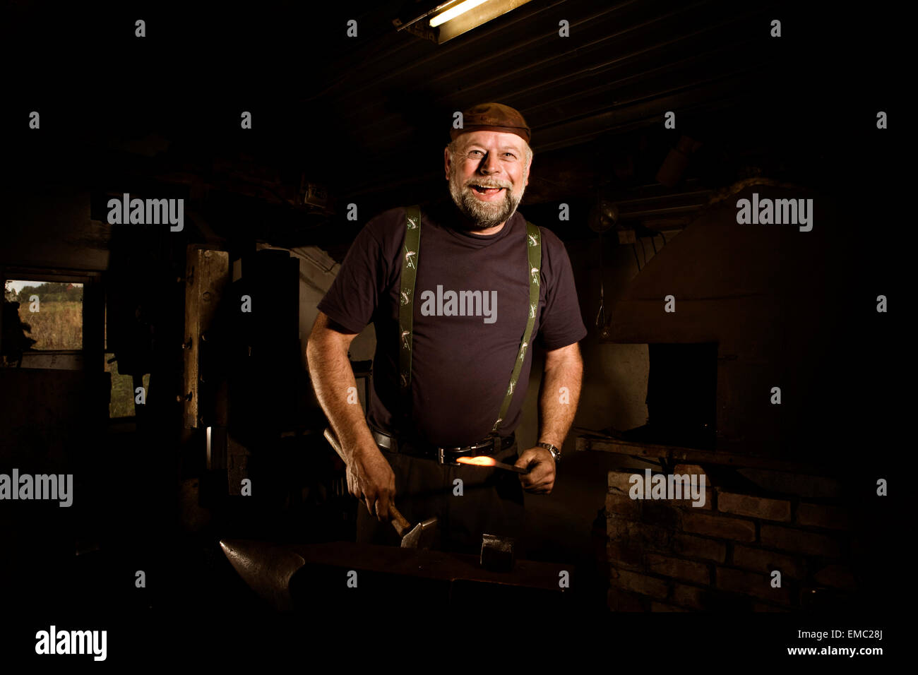 Portrait of happy blacksmith in his workshop Stock Photo - Alamy