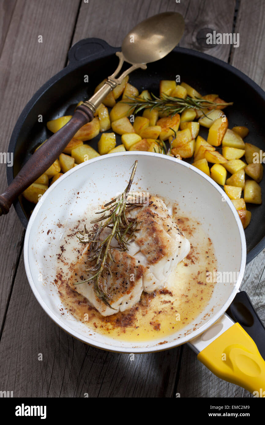 Fried coalfish fillet and roast potatoes Stock Photo - Alamy