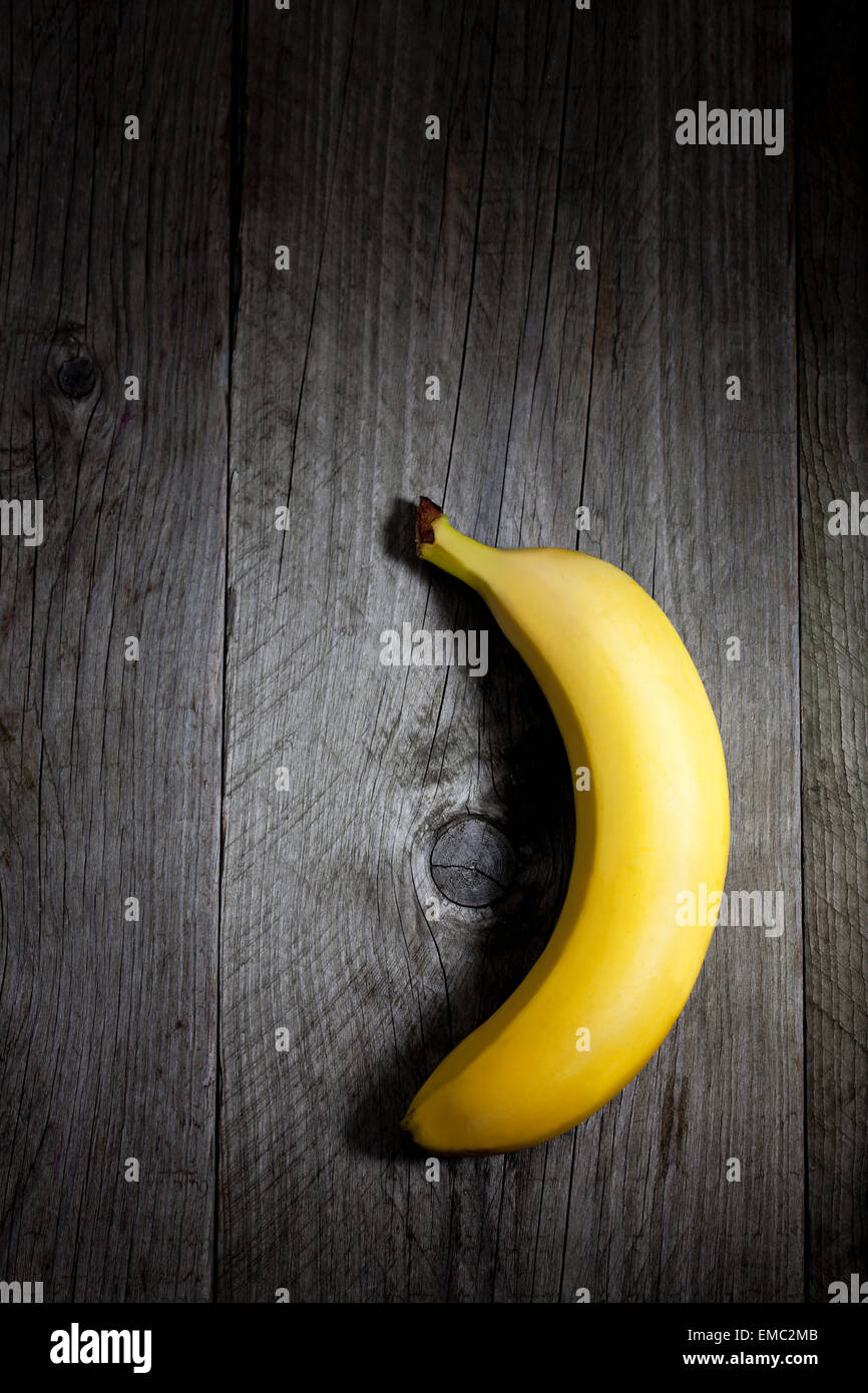 Banana on grey wood Stock Photo - Alamy